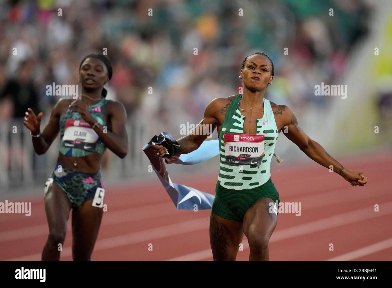 Sha'Carri Richardson grabs the tape as she wins the women's 100 meter ...