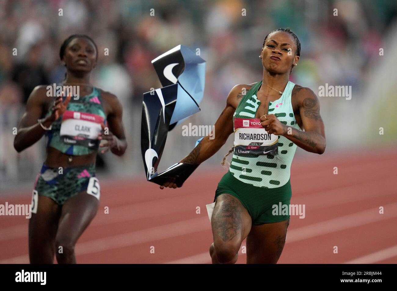 Sha'Carri Richardson grabs the tape as she wins the women's 100 meter ...