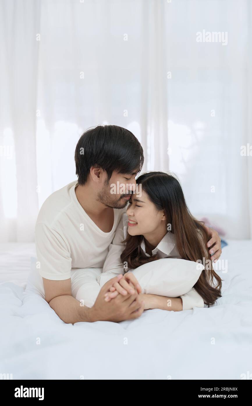 Asian Romantic Couple In Bed Enjoying Sensual Foreplay Happy Sensual Young Couple Lying In Bed