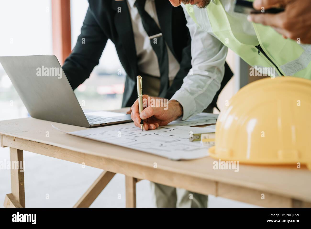 multi ethnic engineer brainstorming and measuring for cost estimating ...