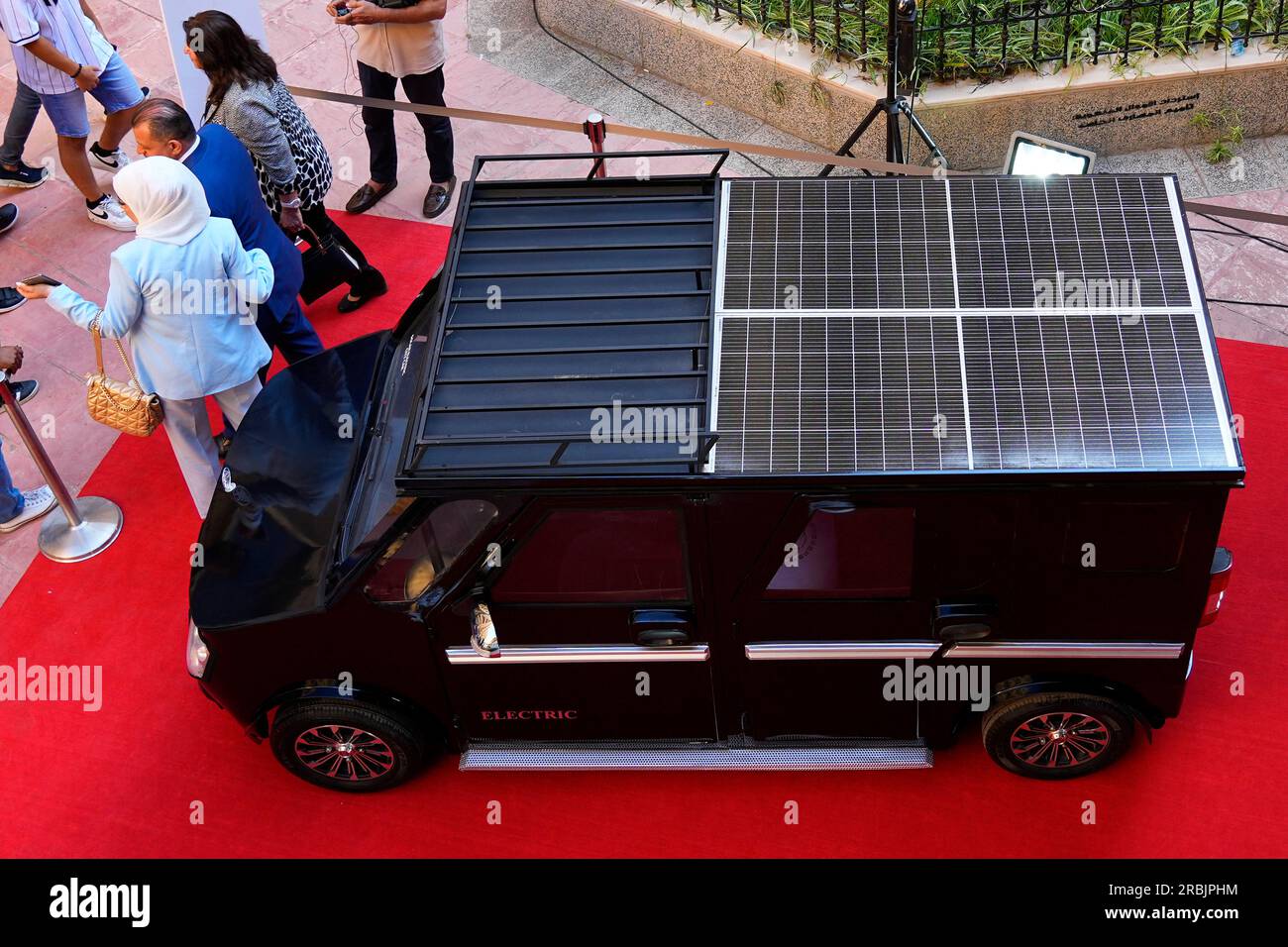 People stand next to a hybrid car called Lira, or Pound, near the ...