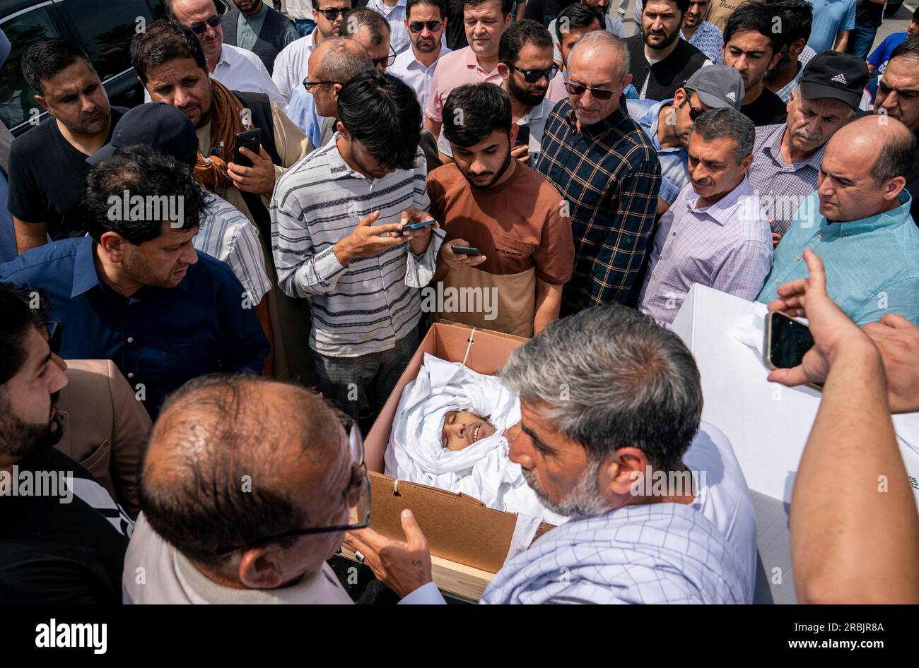 EDS NOTE: GRAPHIC CONTENT - Friends and family view the body of Nasrat Ahmad Yar, 31, during a ...