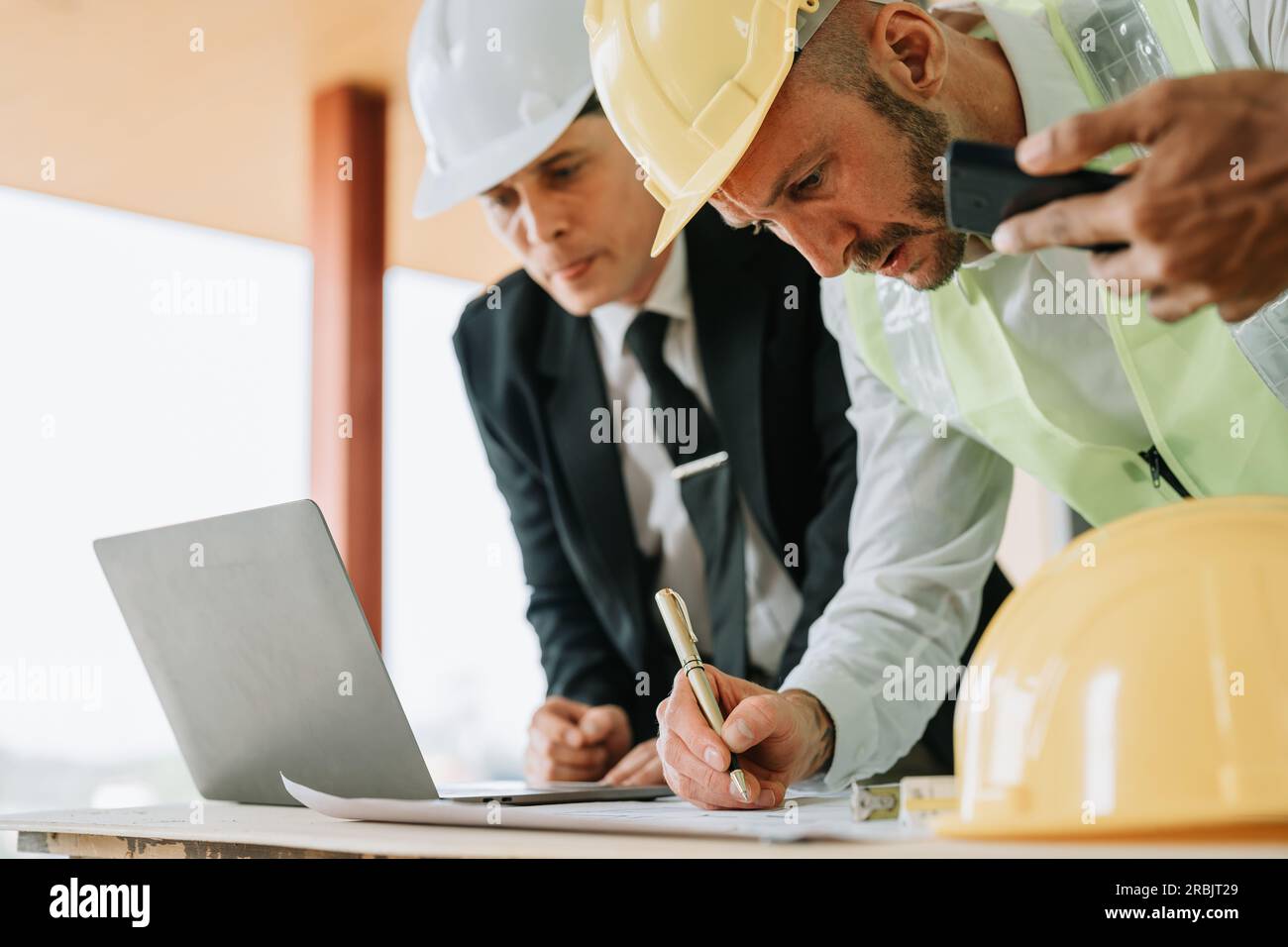 multi ethnic engineer brainstorming and measuring for cost estimating ...