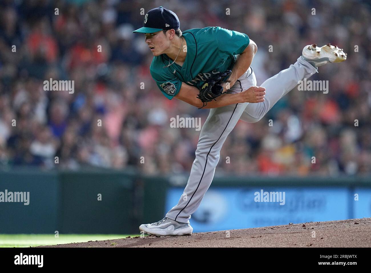 Seattle Mariners starting pitcher Bryan Woo watches a throw to a ...