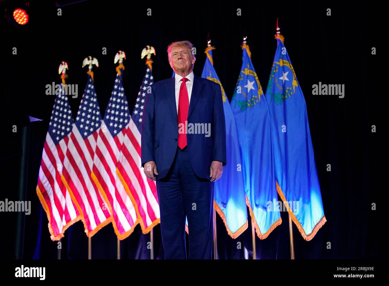 Former President Donald Trump stands before speaking at a campaign ...