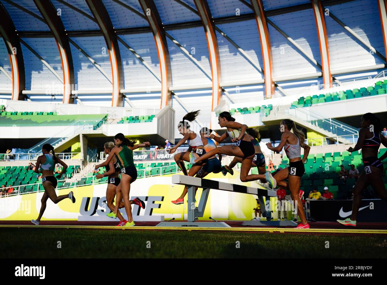 Athletes compete in the women's 3000 meter steeplechase final during ...