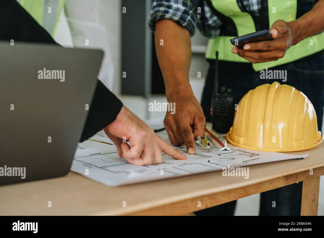 multi ethnic engineer brainstorming and measuring for cost estimating ...