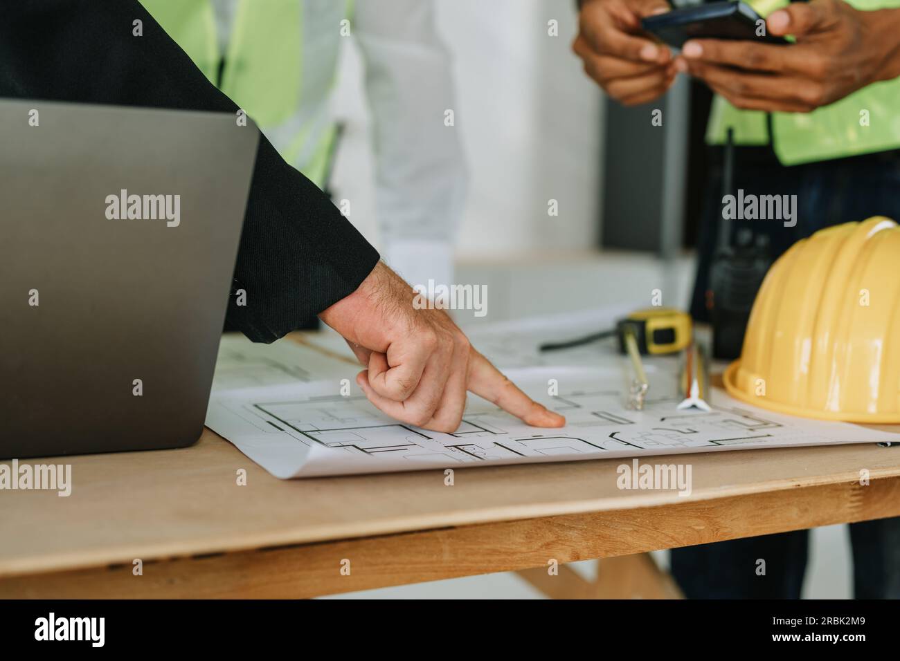 multi ethnic engineer brainstorming and measuring for cost estimating ...