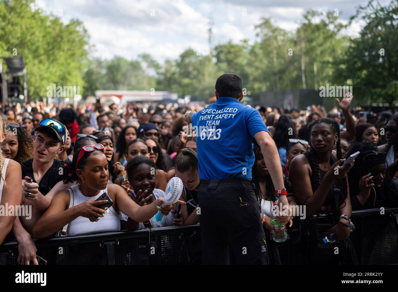 Security passes water to festival goers at the Wireless Music Festival ...