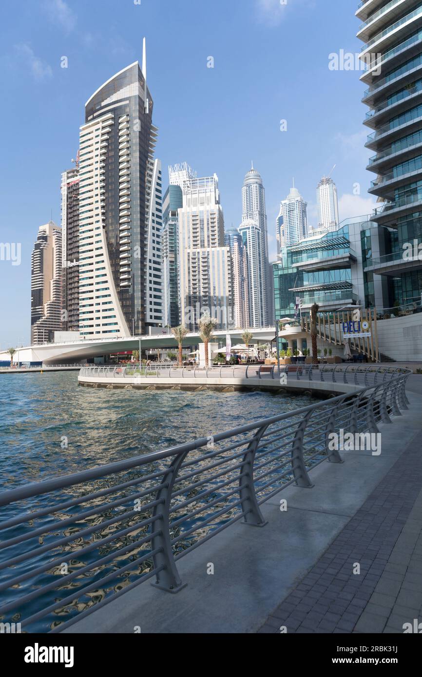 UAE, Dubai, view along the Dubai waterfront walkway towards offices and ...
