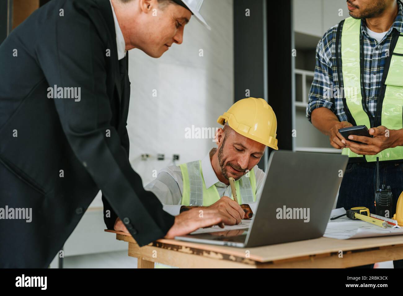 multi ethnic engineer brainstorming and measuring for cost estimating ...