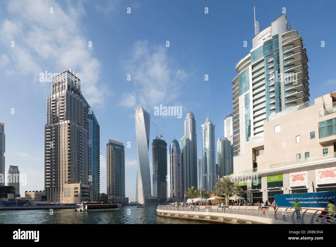 UAE, Dubai, city skyline with the iconic twisted "Cayman Tower" and ...