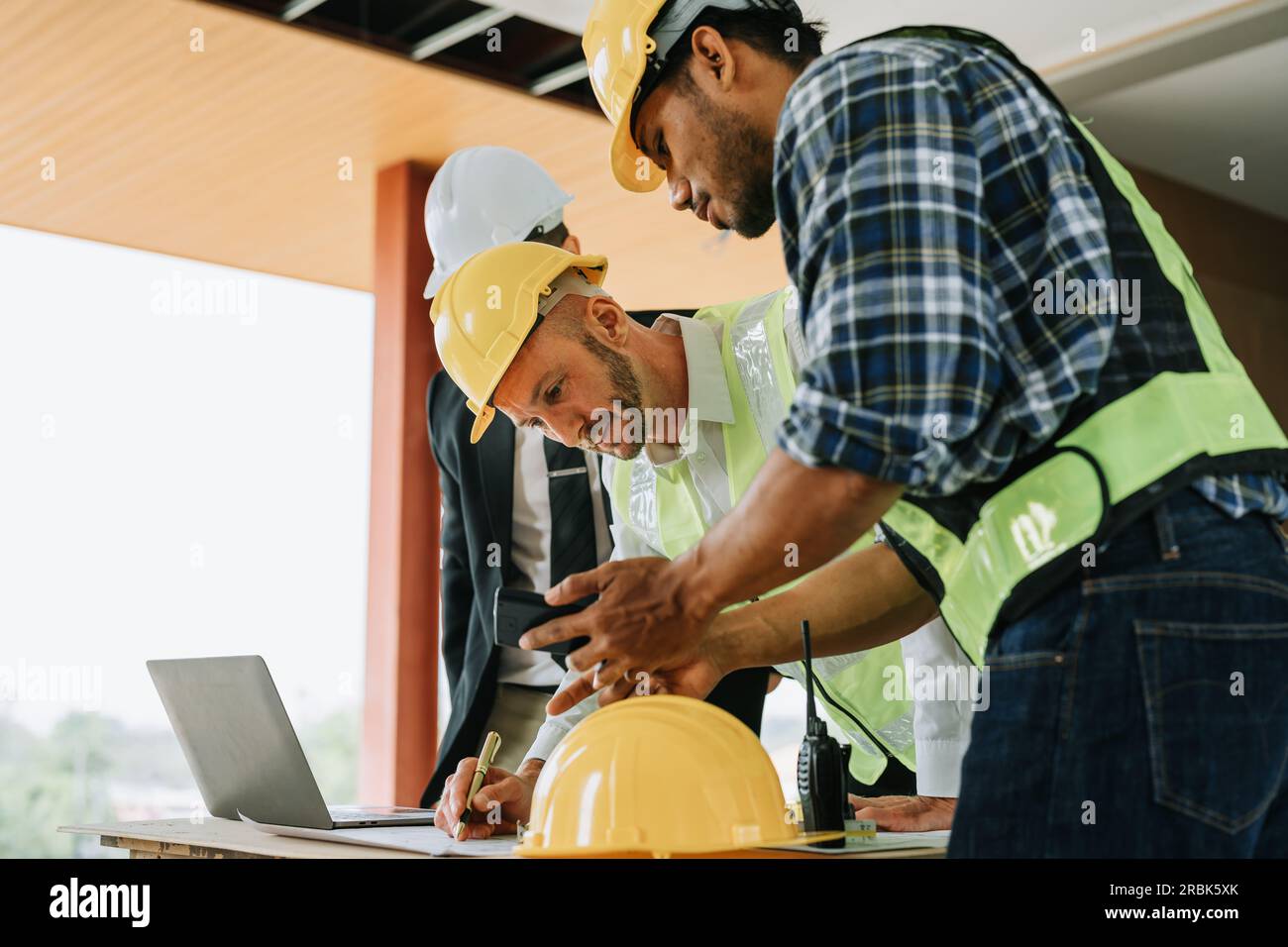 multi ethnic engineer brainstorming and measuring for cost estimating ...