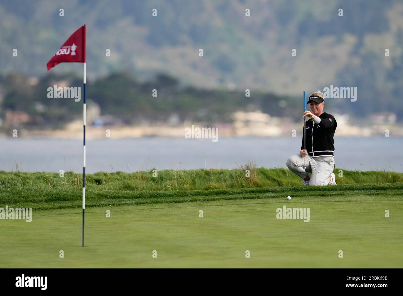 Charley Hull, of England, measures her putt on the 17th green during ...