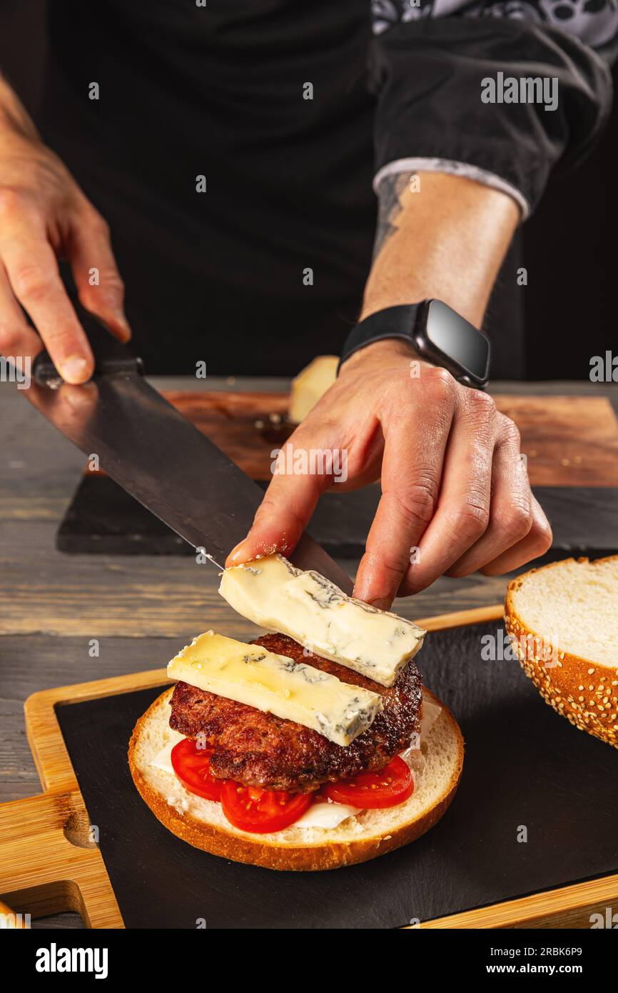 Preparing delicious burgers. The process of making a burger Stock Photo ...