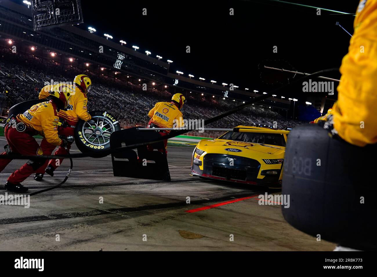 Driver Joey Logano pulls in as his pit crew works during a NASCAR Cup ...