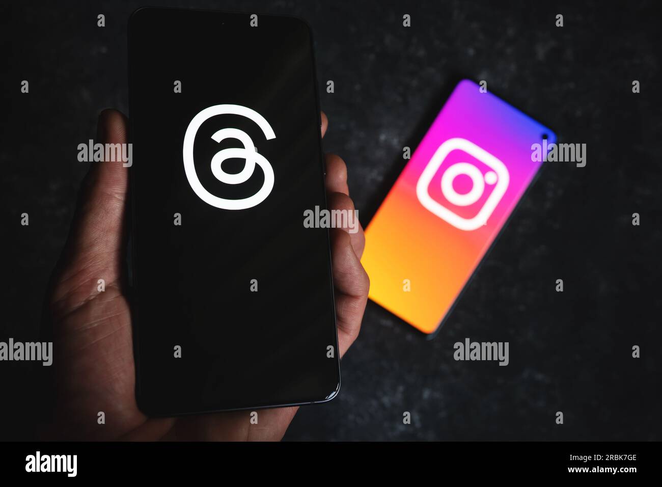 Threads app logo on phone screen with Instagram icon on background ...