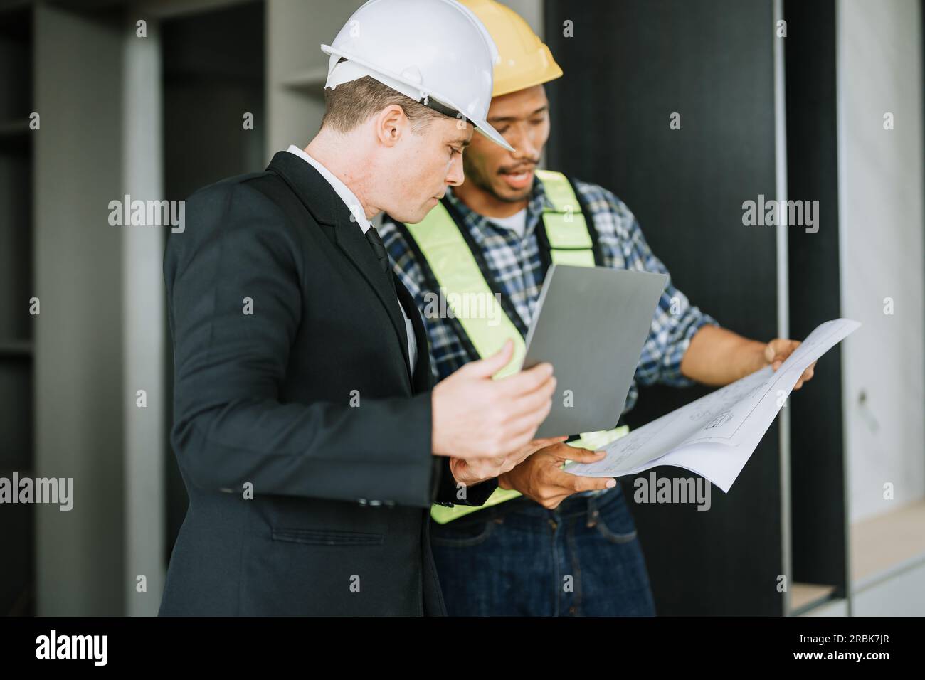 multi ethnic engineer brainstorming and measuring for cost estimating ...