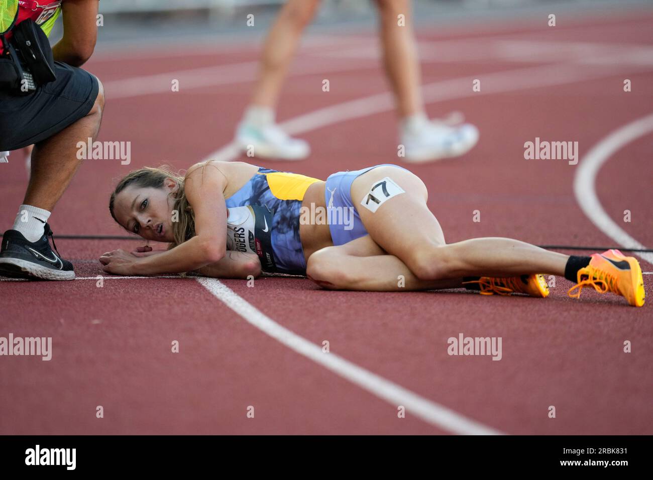 Natosha Rogers lies on the track after finishing third in the women's ...