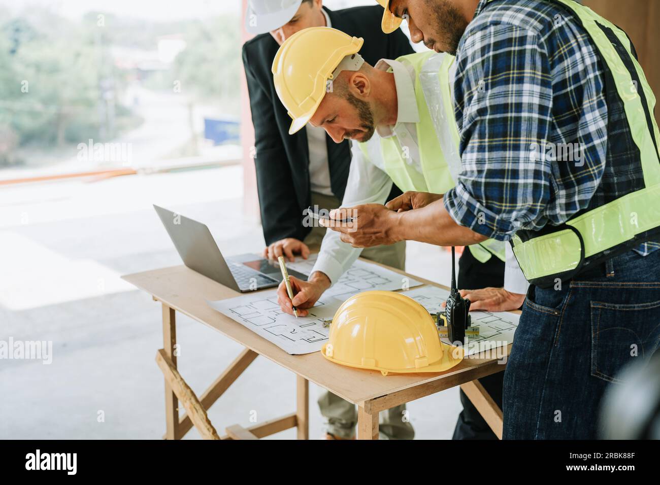 multi ethnic engineer brainstorming and measuring for cost estimating ...