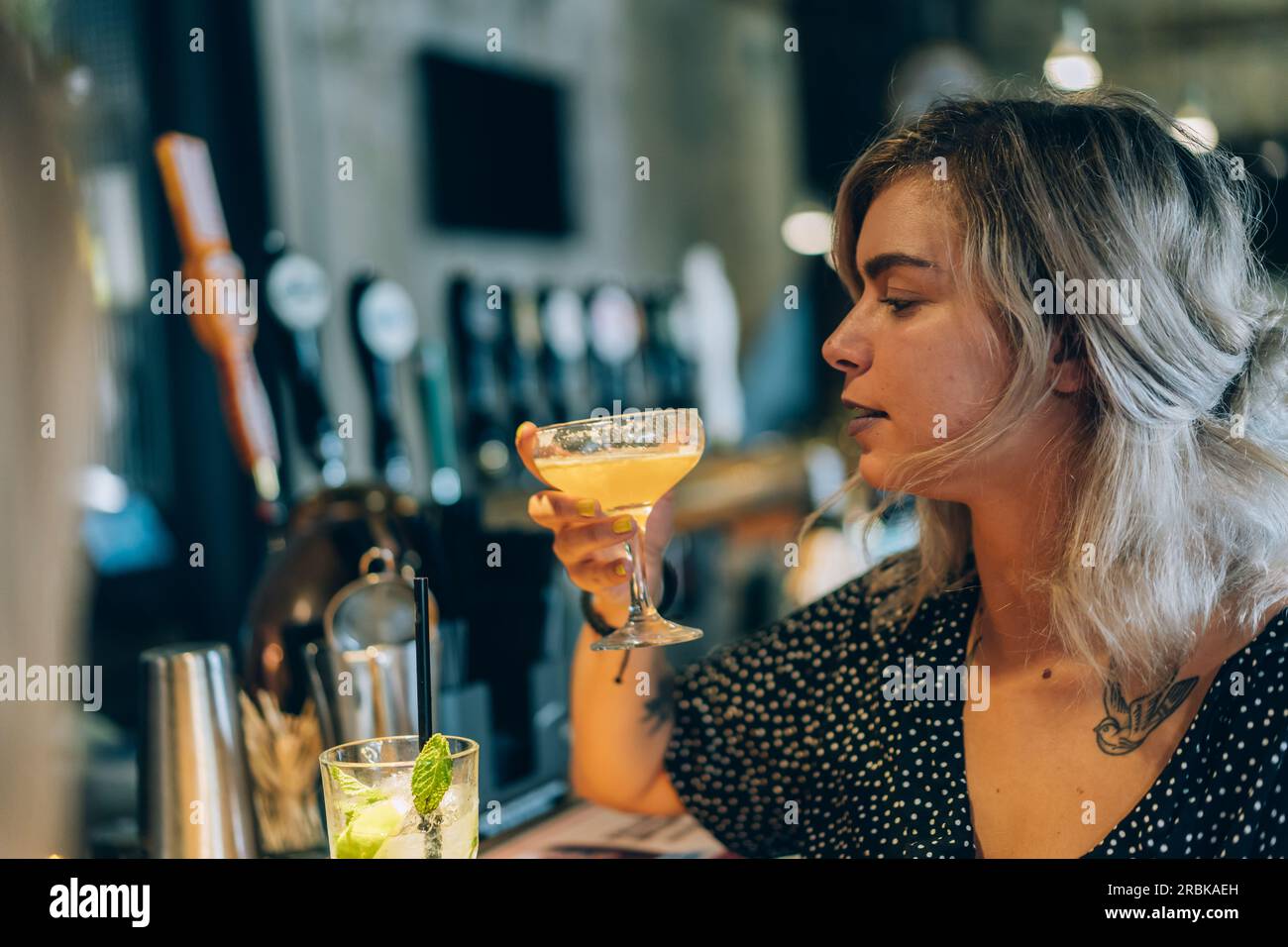 Beautiful Young Girl Drinking In A Bar Stock Photo - Alamy