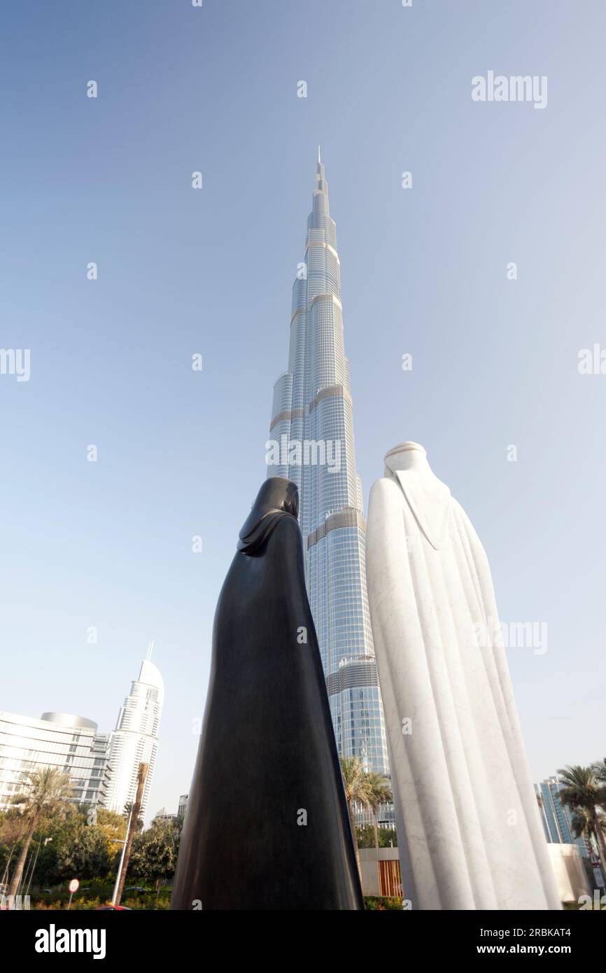 UAE, Dubai, statue 'Together' by Lutfi Romhein with the Burj Khalifa ...