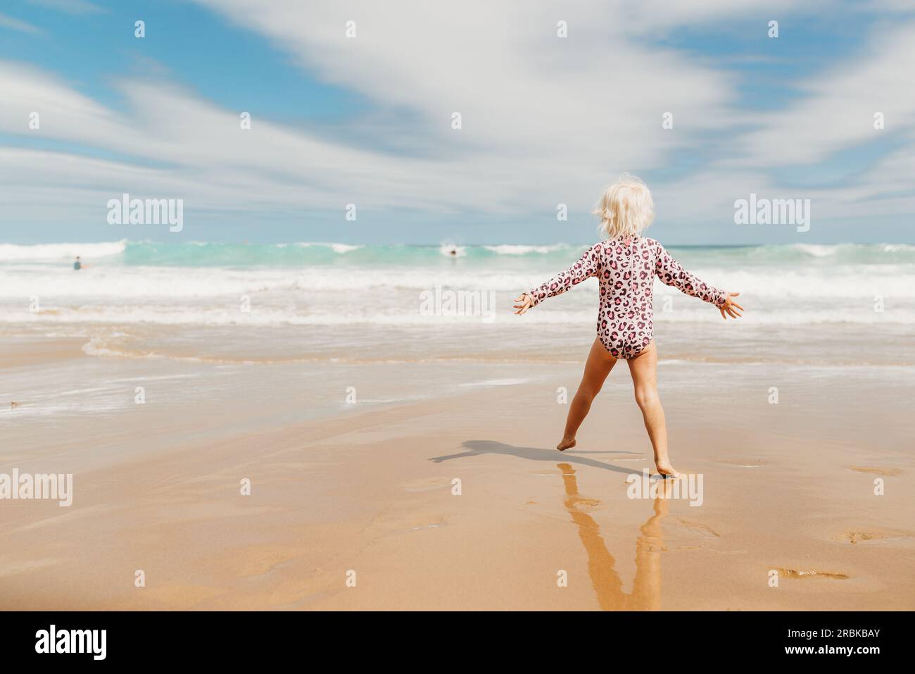 Young Girl Running into the Ocean in Australia Stock Photo - Alamy