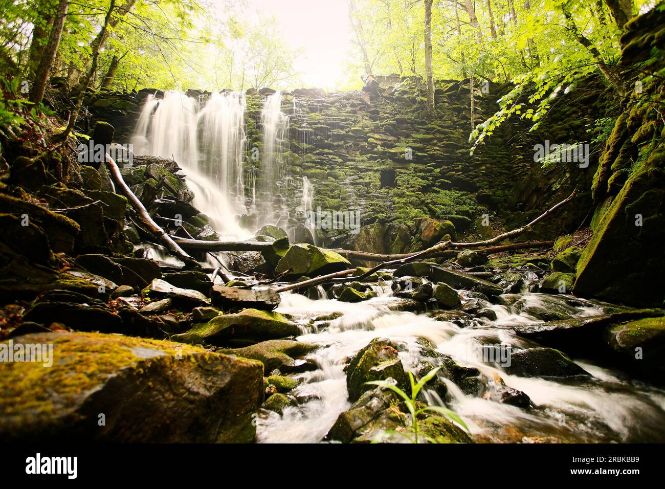 A waterfall flowing over a 19th century slate dam from an old mill ...