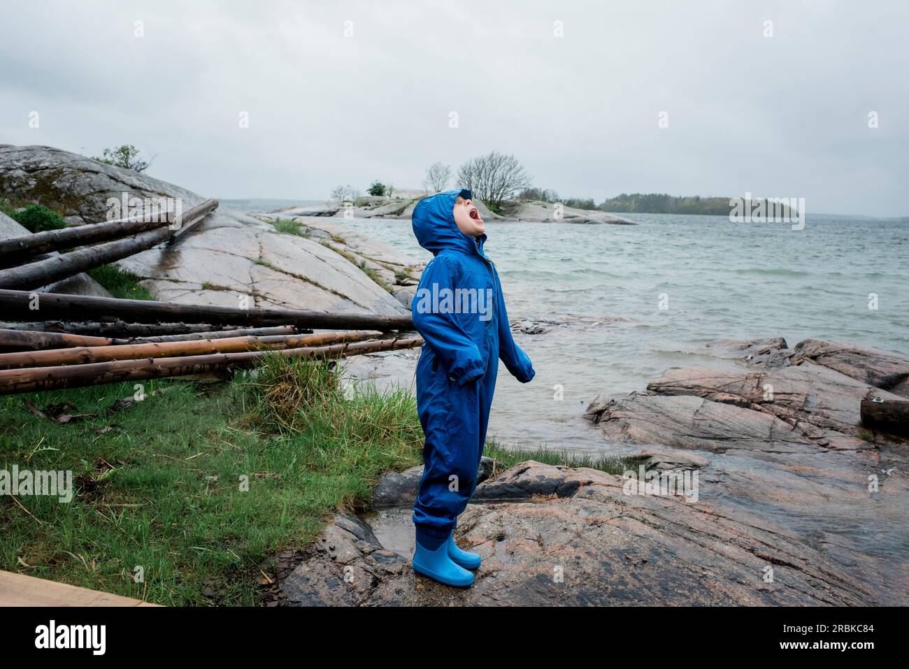 young boy drinking the rain at the beach Stock Photo - Alamy