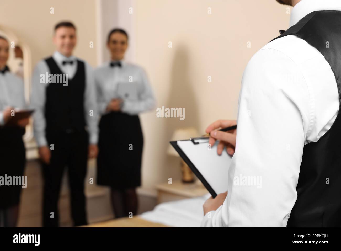 Group of people attending professional butler courses in hotel, closeup ...