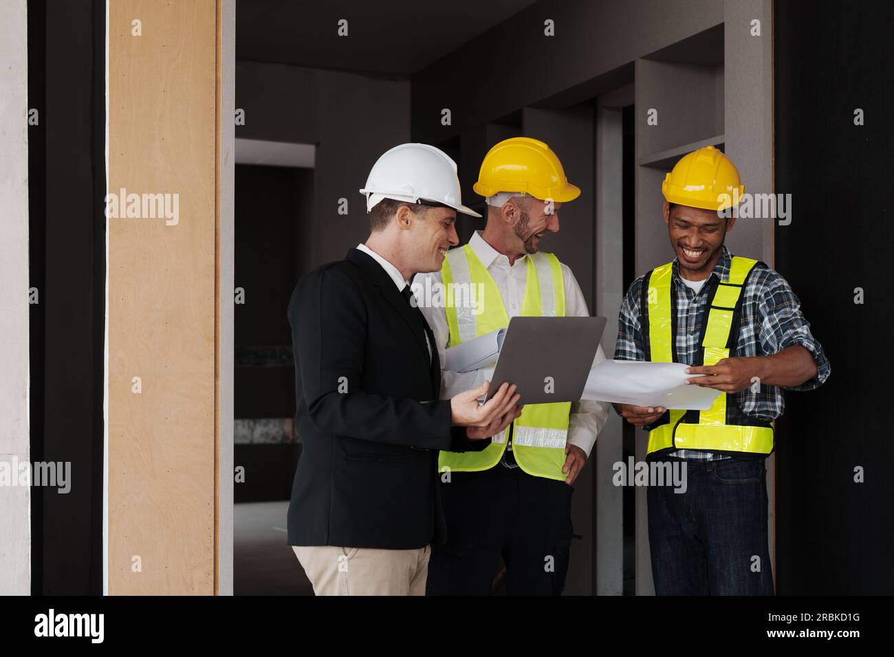 multi ethnic engineer brainstorming and measuring for cost estimating ...