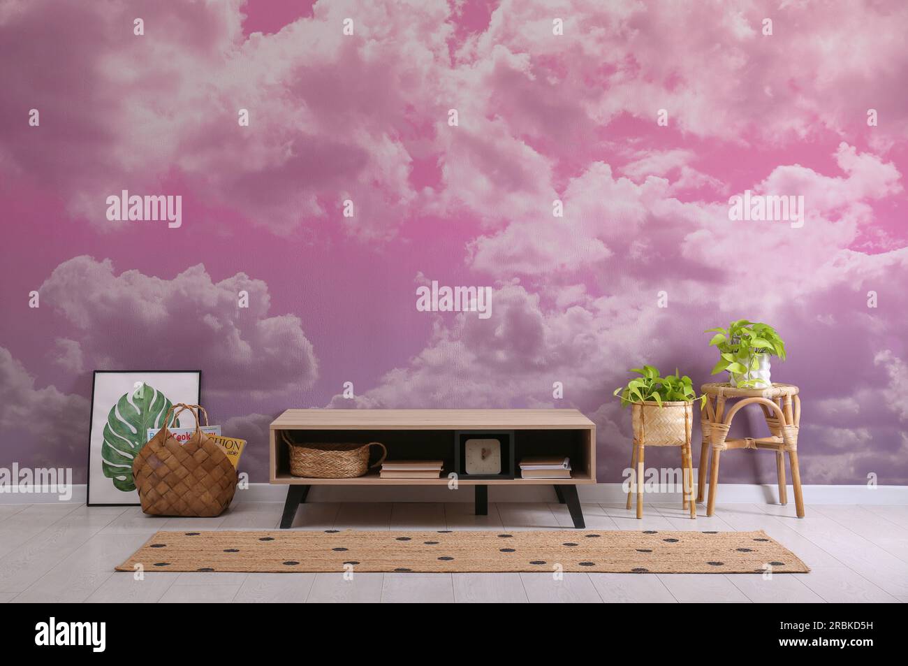 Pink sky with clouds on wallpaper in furnished room. Beautiful interior ...