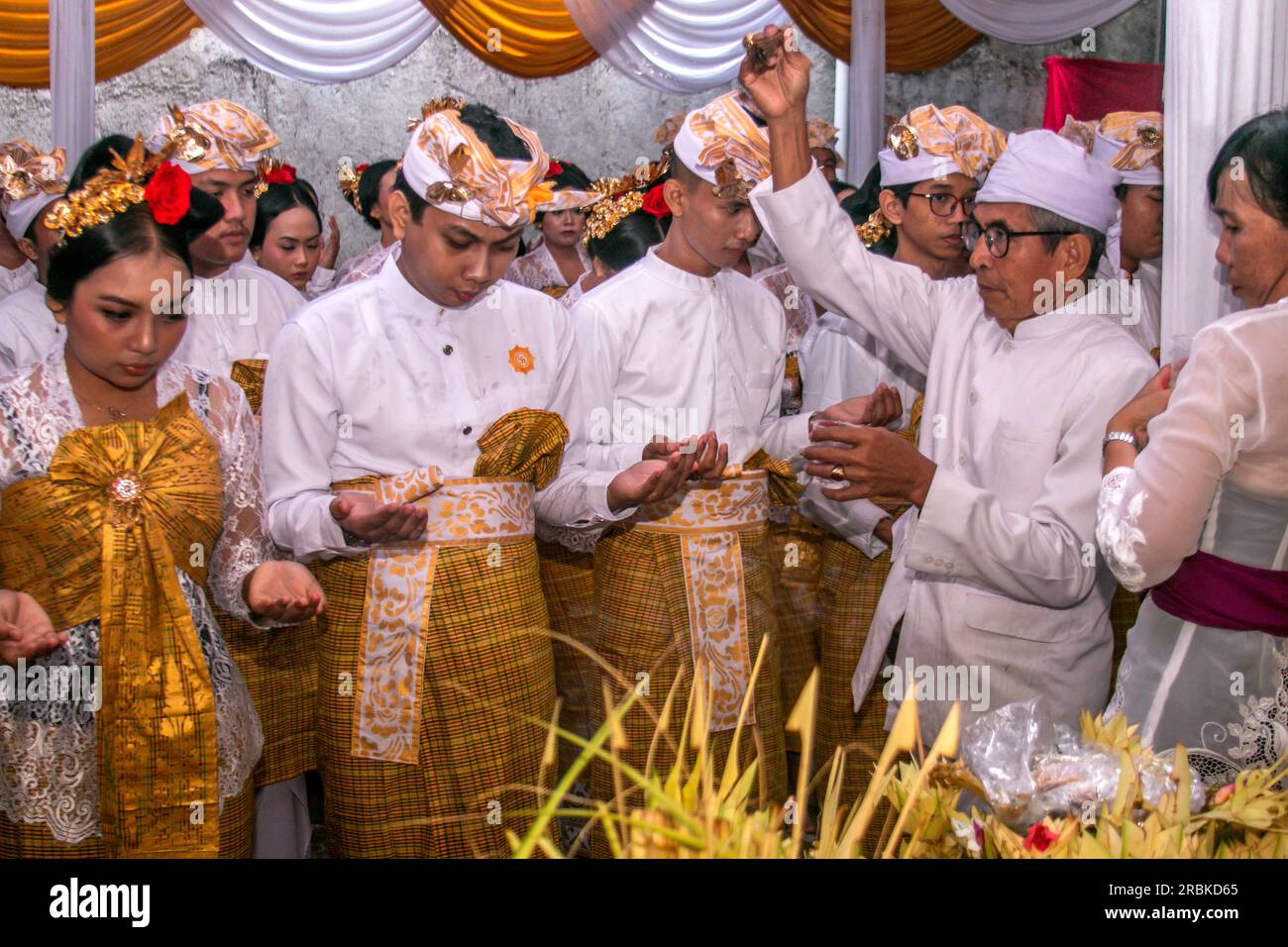 Participants carry out a series of rituals at the Giri Kusuma Temple ...