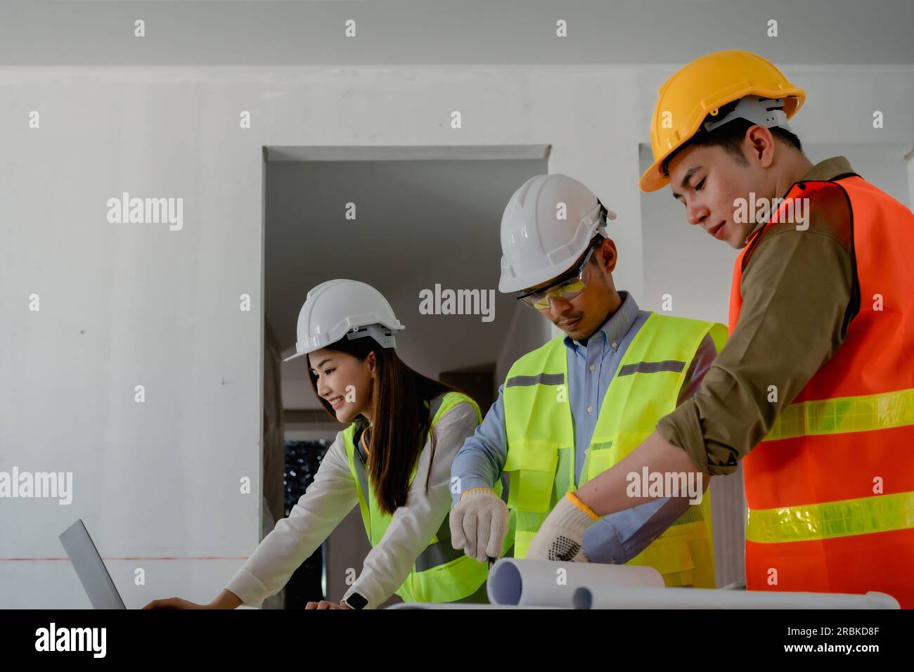 multi ethnic engineer brainstorming and measuring for cost estimating ...