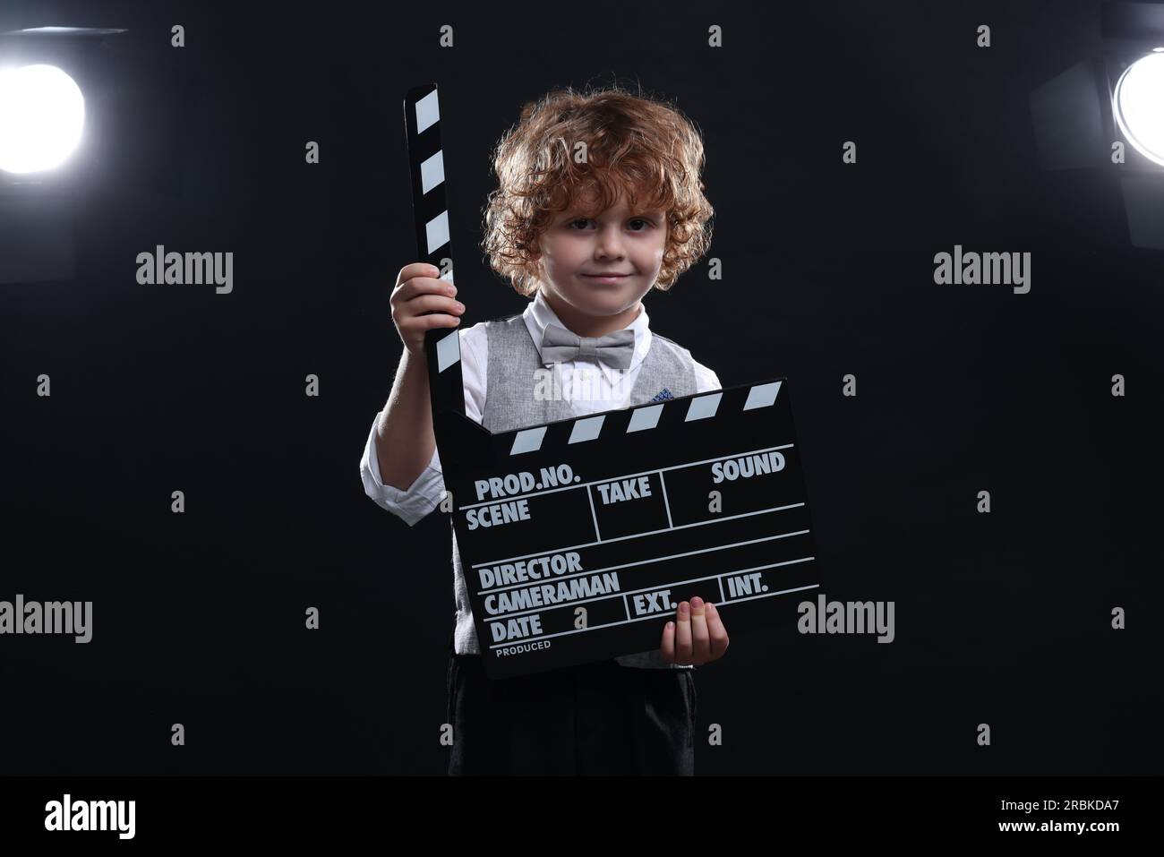 Cute boy with clapperboard on stage. Little actor Stock Photo - Alamy