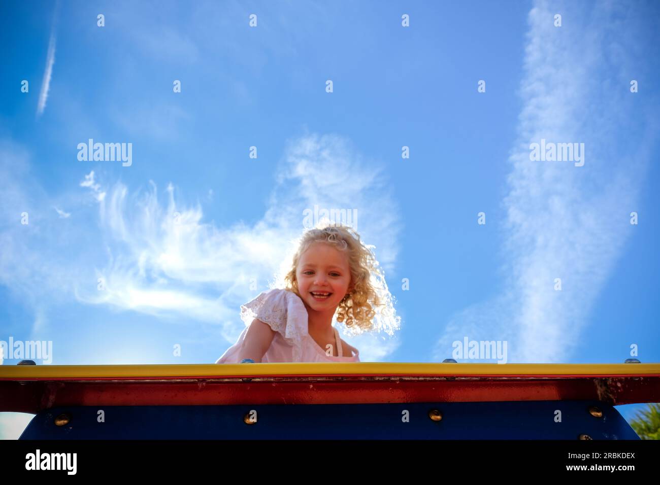 little girl looking down at camera from above at playground climbing ...