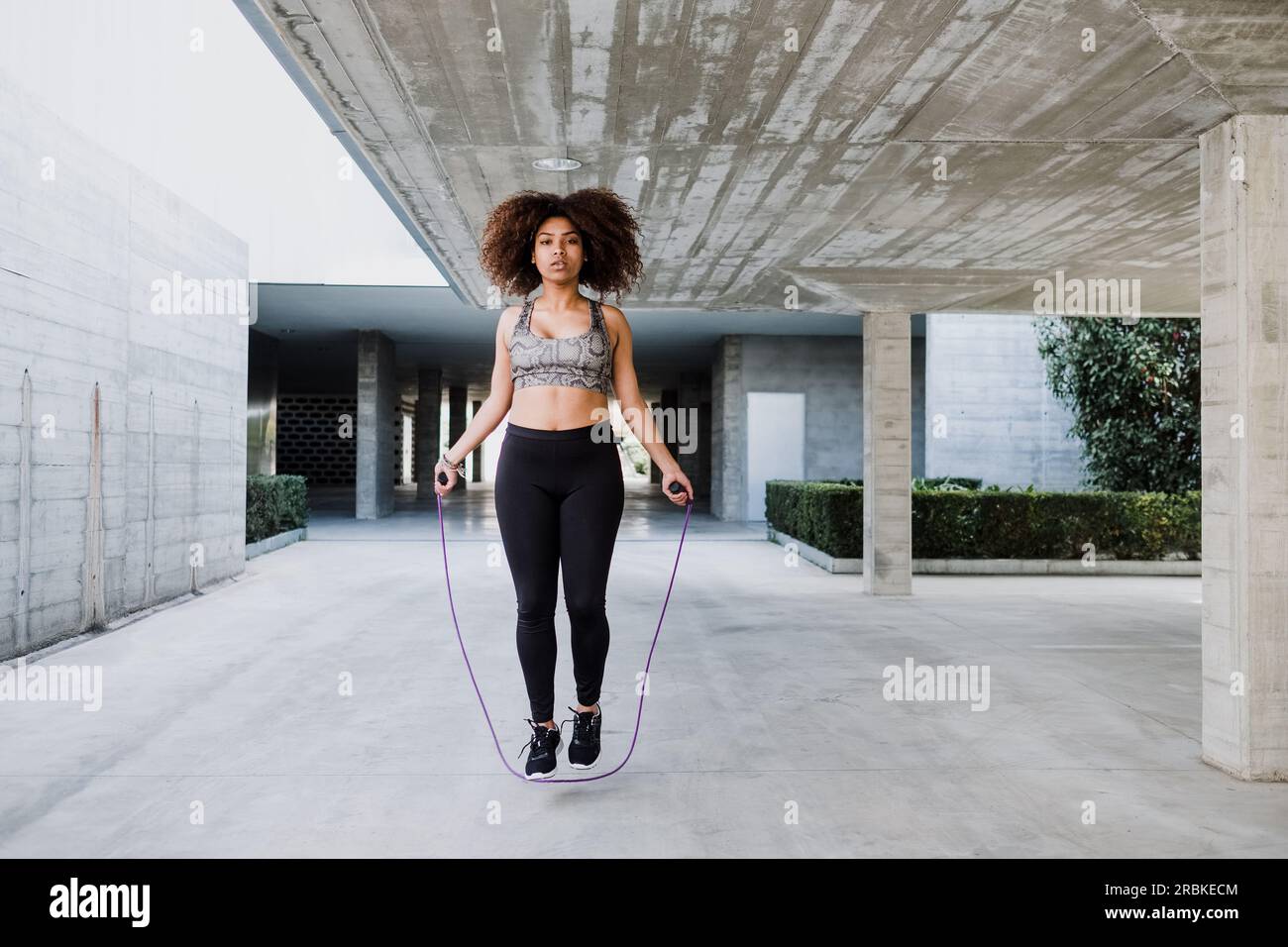 Curvy African American Woman Skipping Rope In Urban Area Stock Photo ...