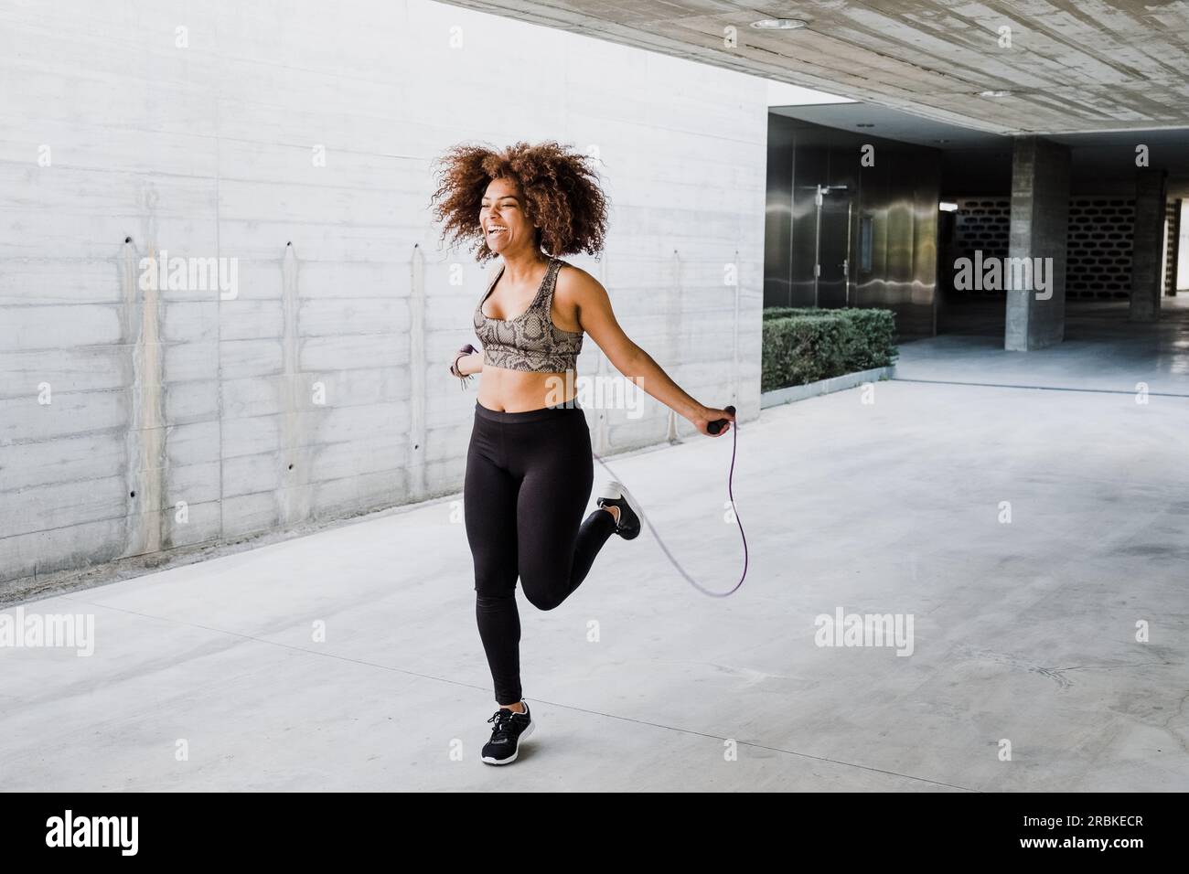 Curvy African American Woman Skipping Rope In Urban Area Stock Photo ...