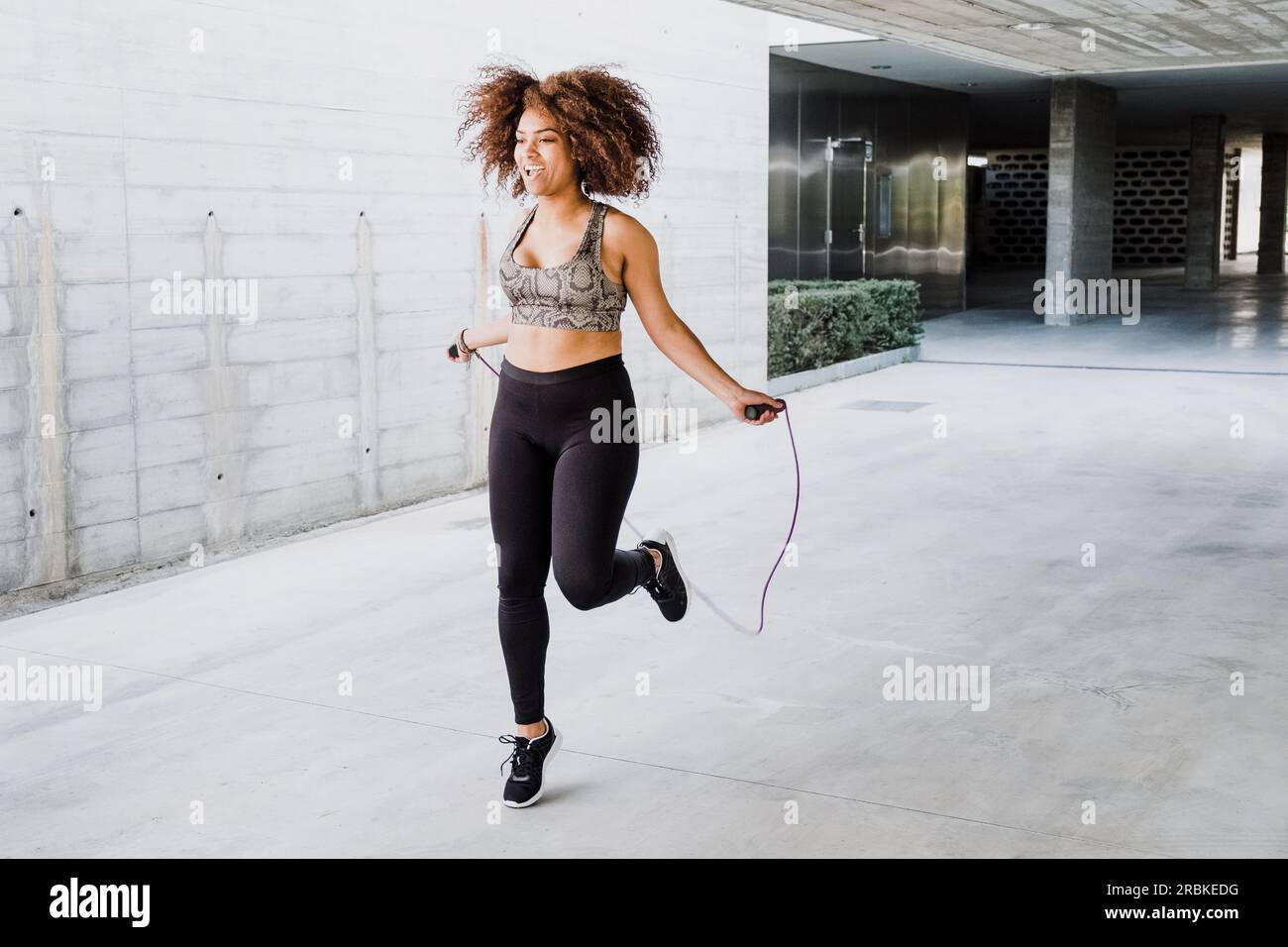 Curvy African American Woman Skipping Rope In Urban Area Stock Photo ...