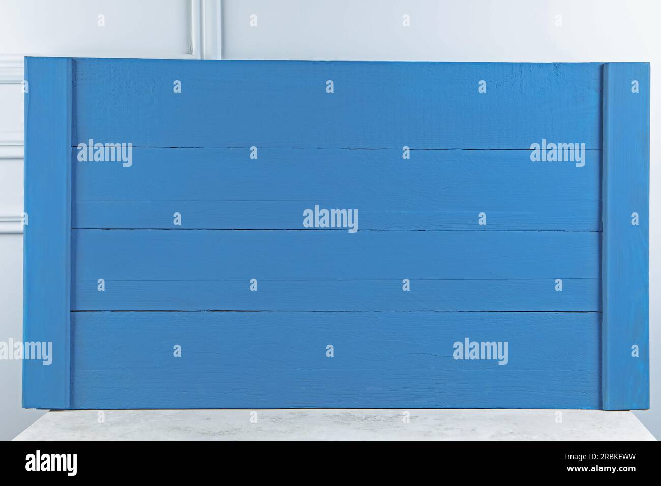Texture of blue wooden board on table near white wall Stock Photo - Alamy