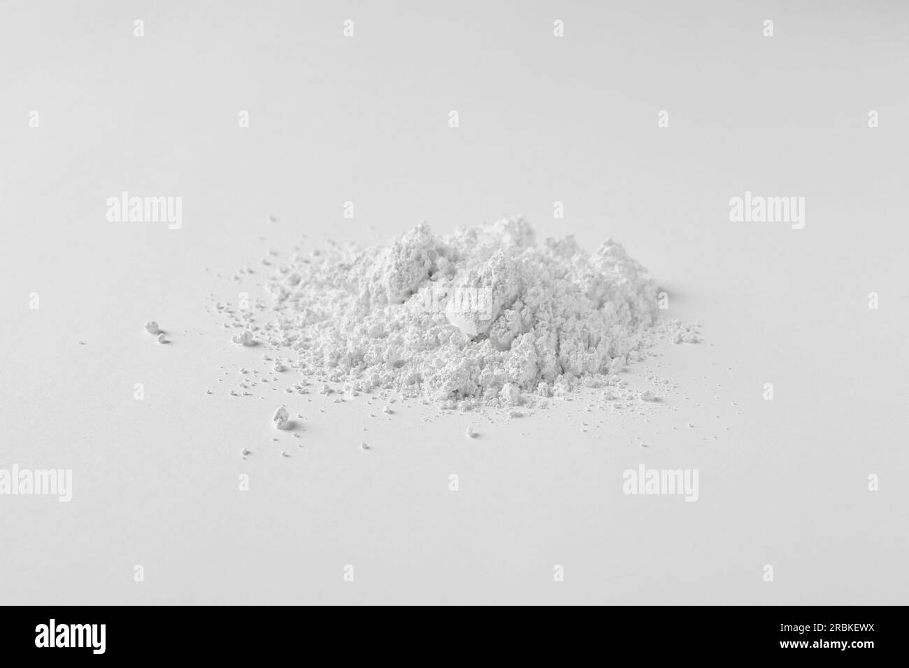Heap of calcium carbonate powder on white background Stock Photo - Alamy