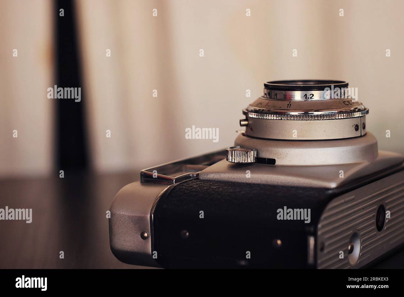 Analog camera on top of a black table Stock Photo - Alamy
