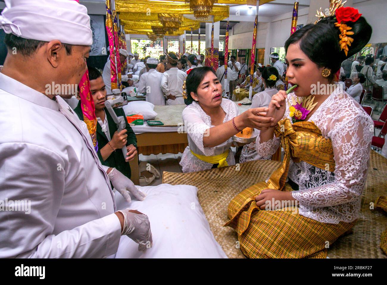 Participants carry out a series of rituals at the Giri Kusuma Temple ...