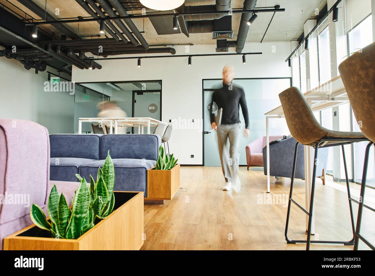 motion blur of businessman holding laptop and walking in contemporary ...