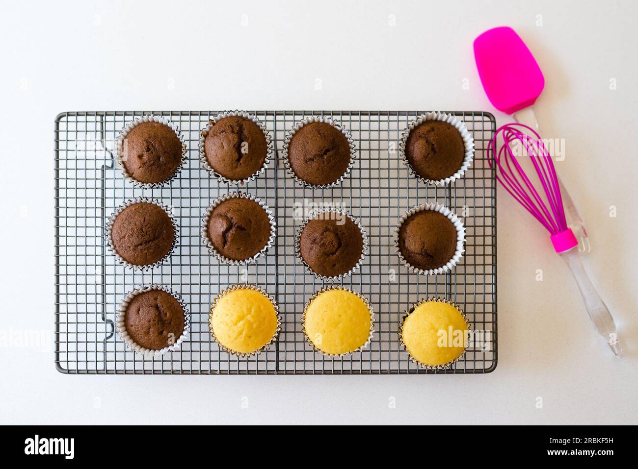 Flat lay of cupcakes cooling on cooling rack with baking tools Stock ...