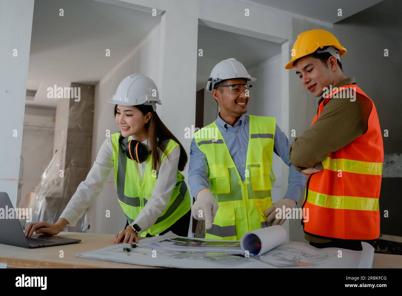 multi ethnic engineer brainstorming and measuring for cost estimating ...