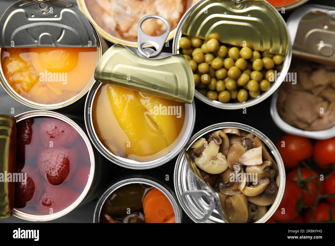 Open tin cans with different products as background, top view Stock ...
