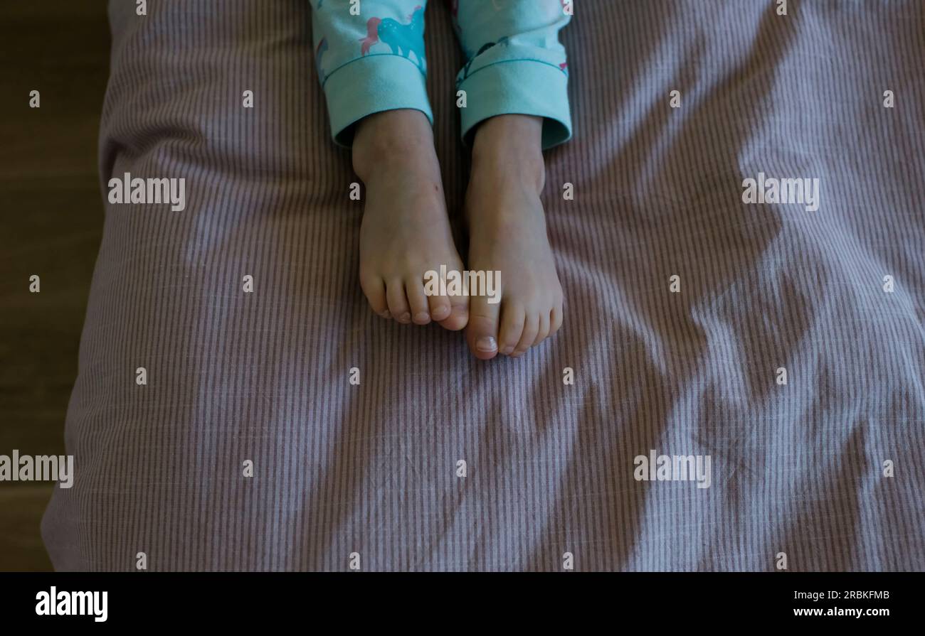 young Child's feet pointing their toes on a bed Stock Photo - Alamy