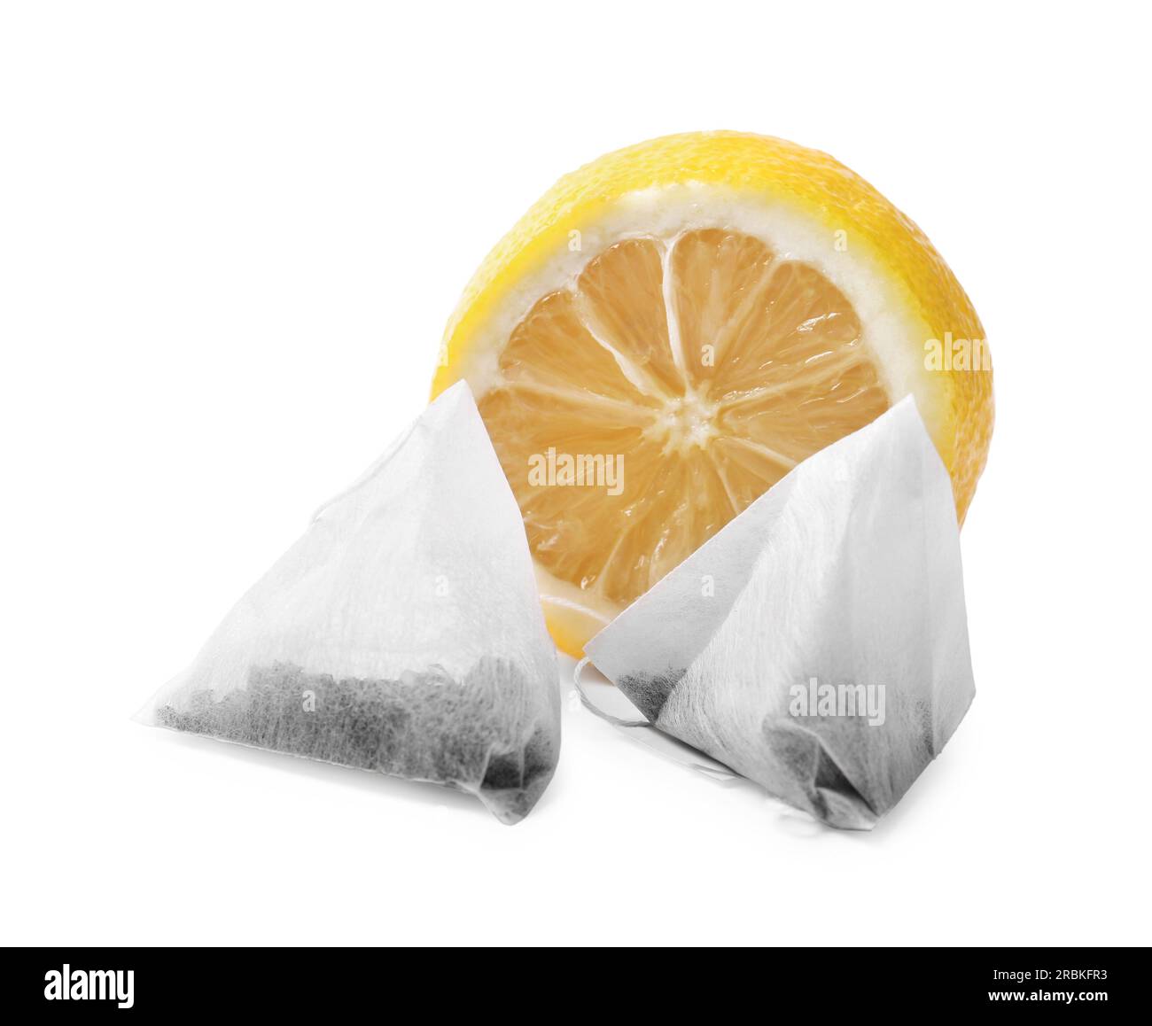 Tea bags and half of lemon on white background Stock Photo - Alamy