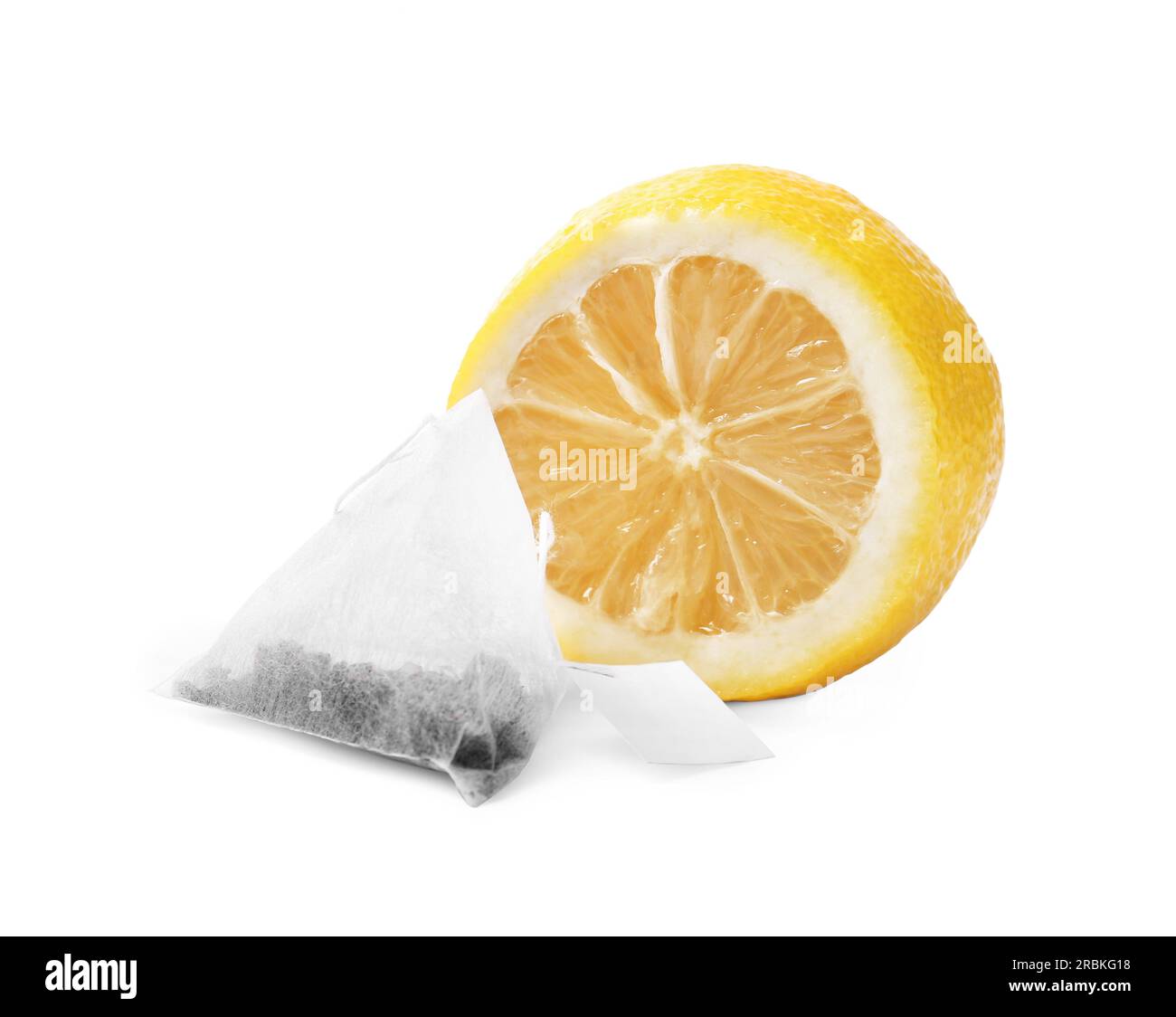 Tea bag and half of lemon on white background Stock Photo - Alamy